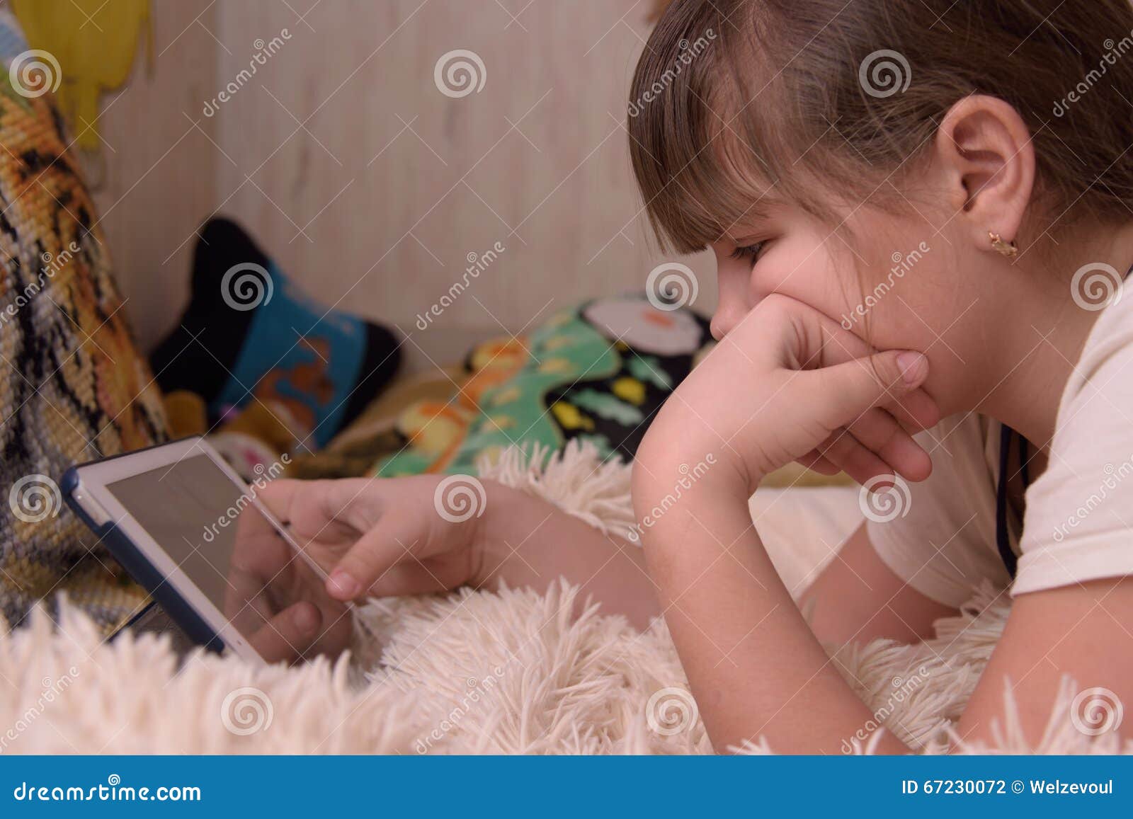Girl uses tablet computer. stock photo. Image of internet - 67230072