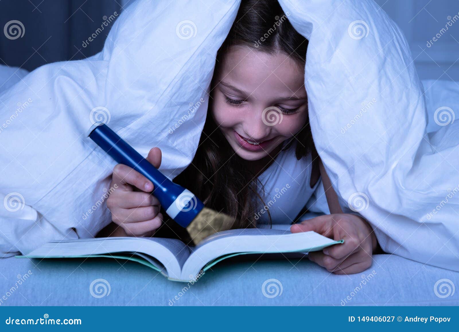 Girl Using Flashlight while Reading Book Stock Image - Image of girl ...