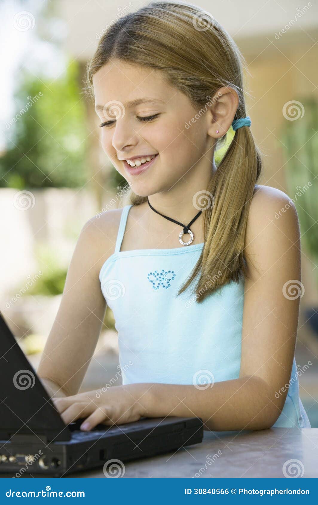 Girl Using Laptop on Outdoor Patio Stock Photo - Image of typing, girls ...