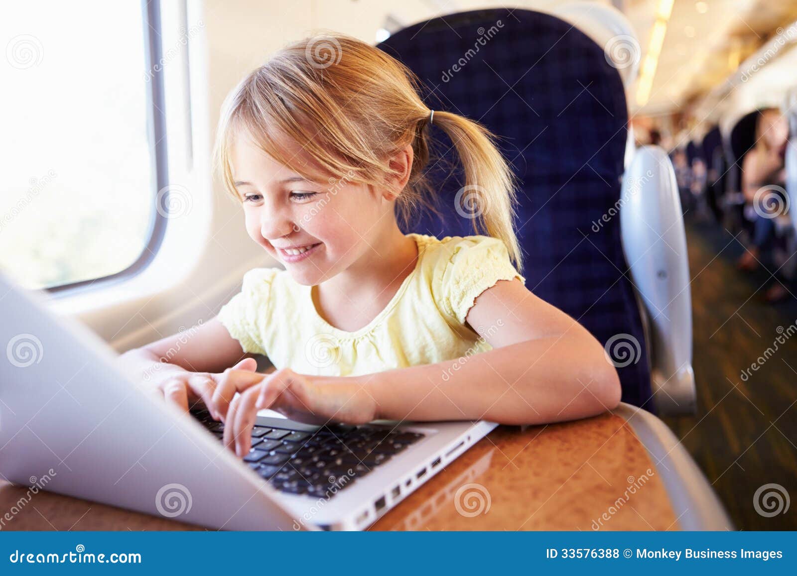 Girl Using Laptop on Train stock photo. Image of computer - 33576388