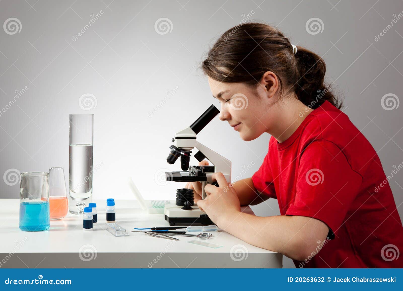 Girl using microscope stock photo. Image of examining - 20263632