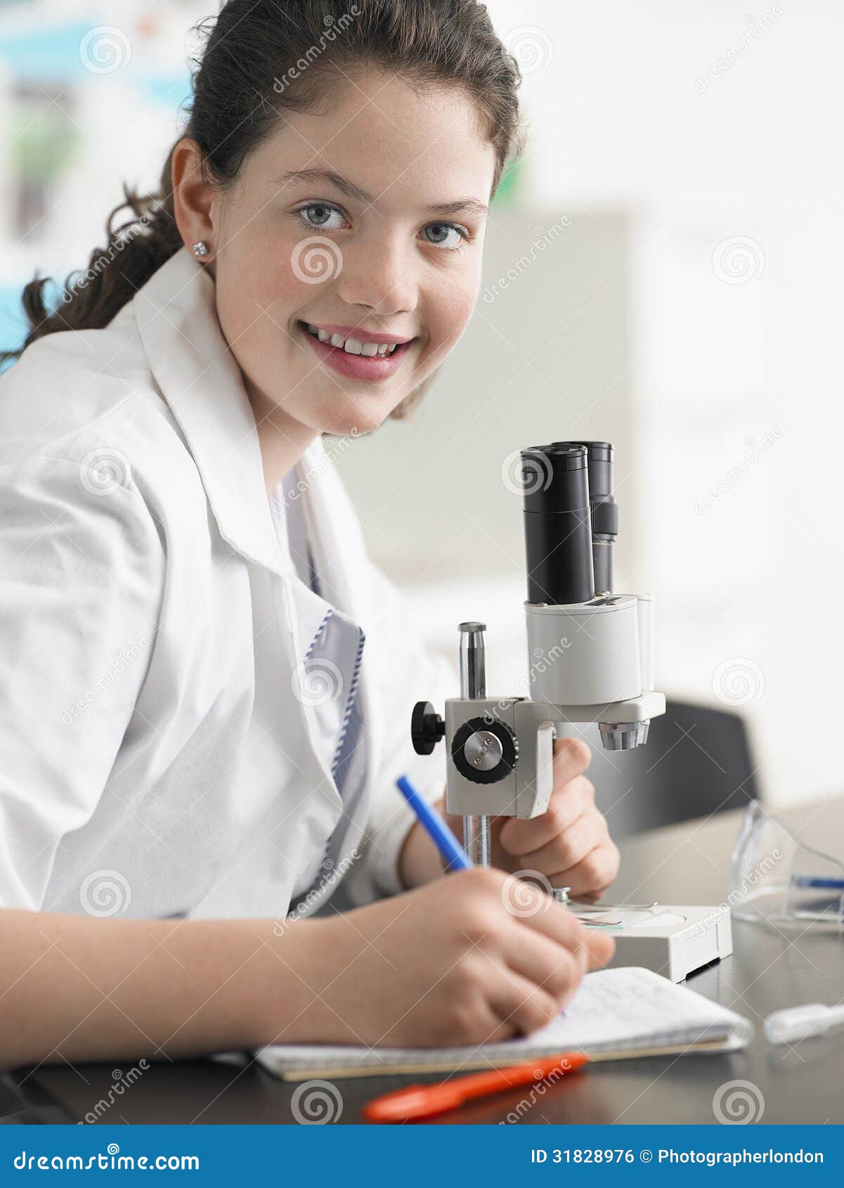 Girl Using Microscope and Taking Notes Stock Photo - Image of ...