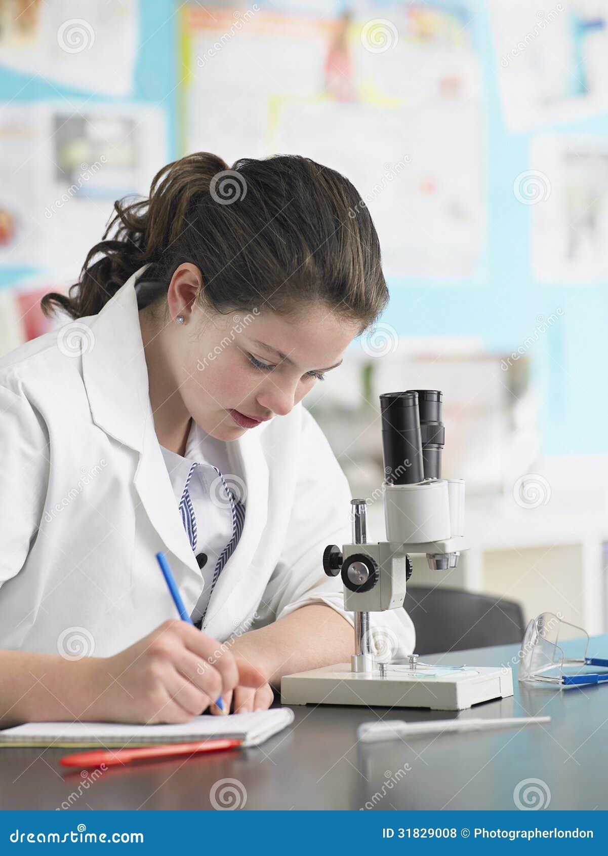Girl Using Microscope and Taking Notes Stock Photo - Image of medical ...