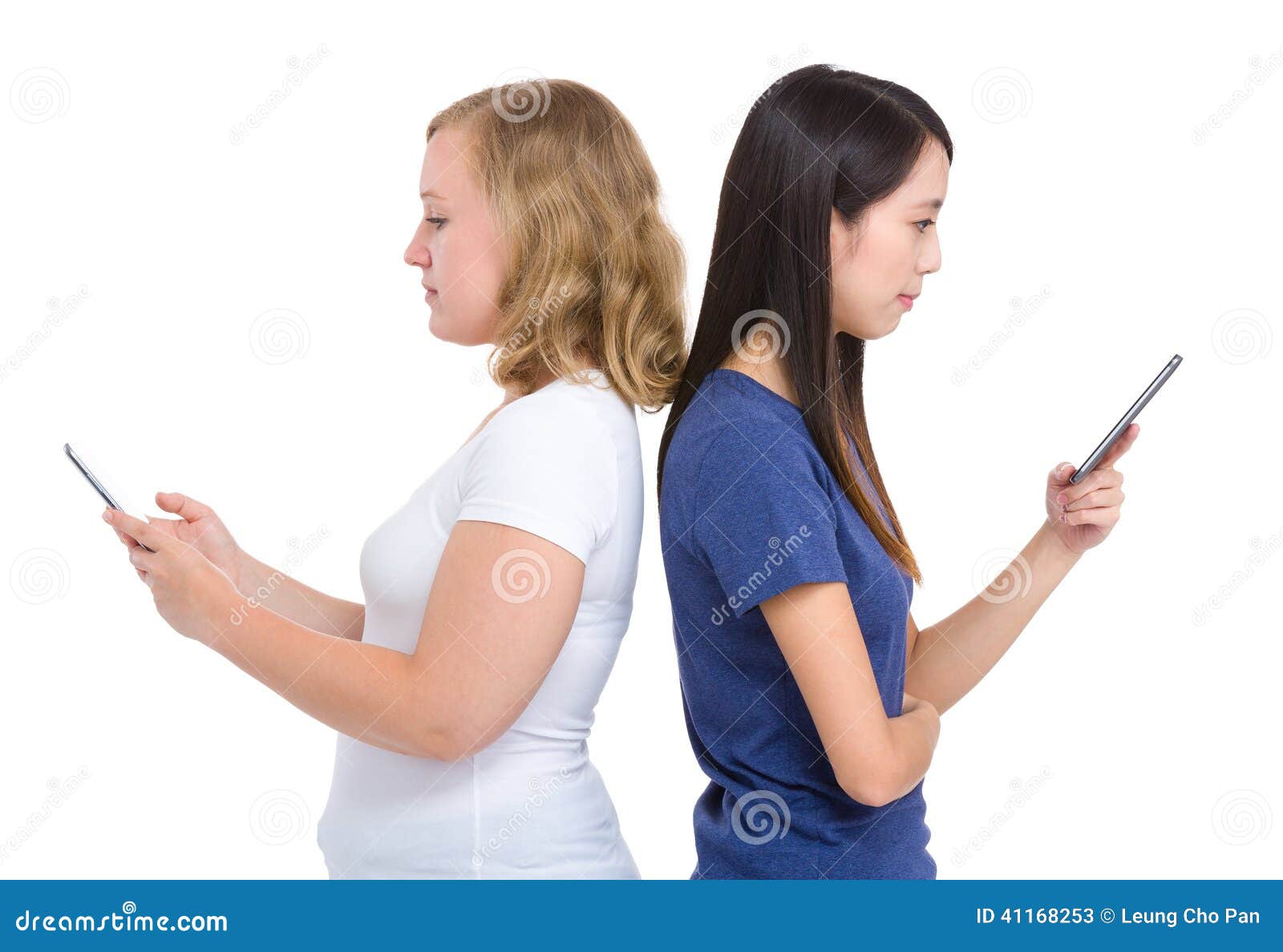 Girl Using Mobile Standing Back To Back Stock Image - Image of blond ...