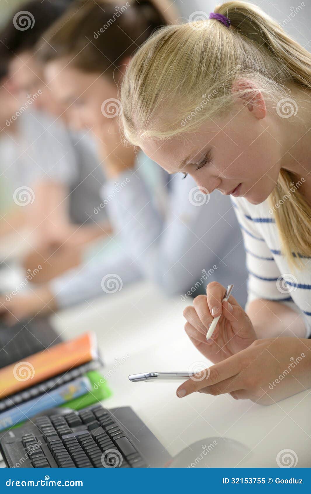 Girl using phone at school stock image. Image of blond - 32153755