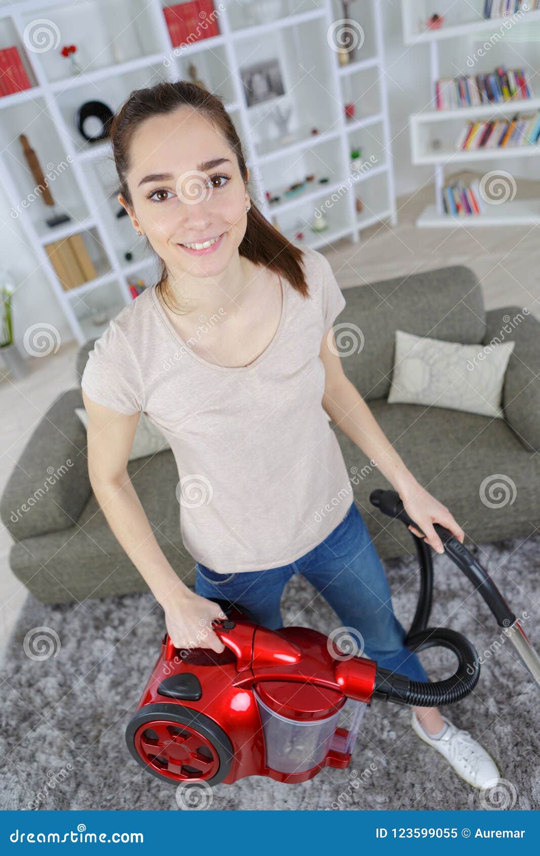 Girl vacuuming the carpet stock image. Image of indoors - 123599055