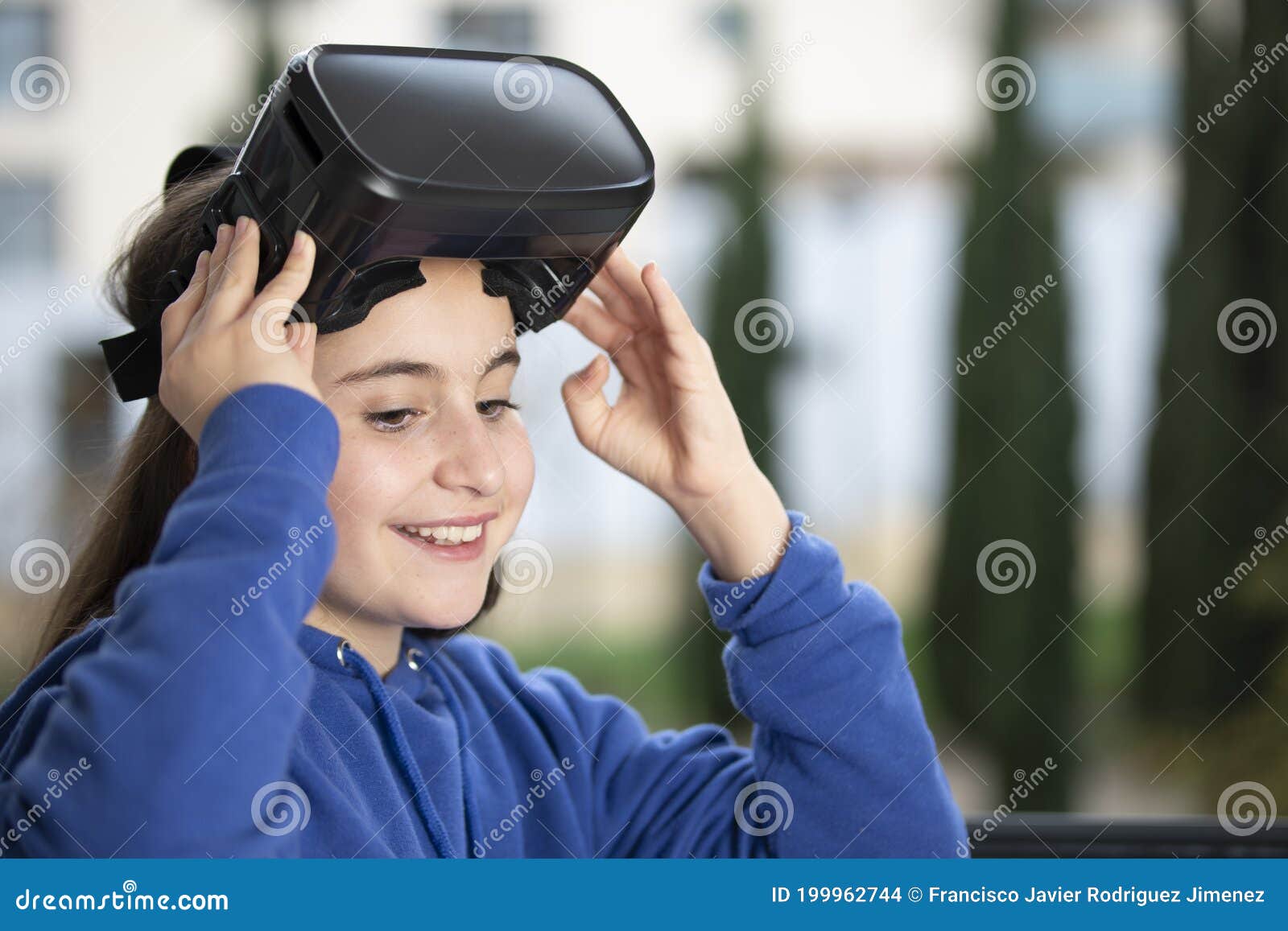 Girl with Virtual Reality Glasses Smiling Distracted Stock Photo ...