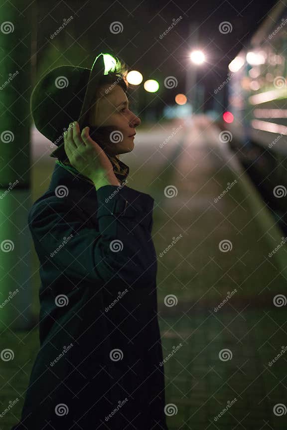 A Girl Is Waiting For Someone At Night At A Railway Station A Photo