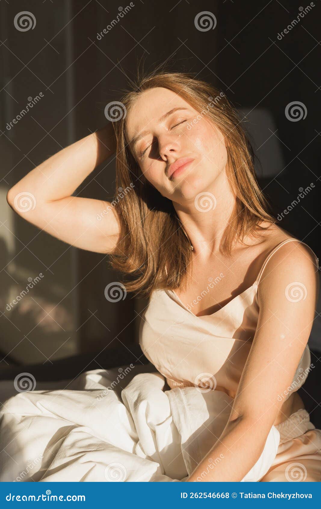 Girl Portrait Is Waking Up In Morning Stretches In Bed And Sun Shines