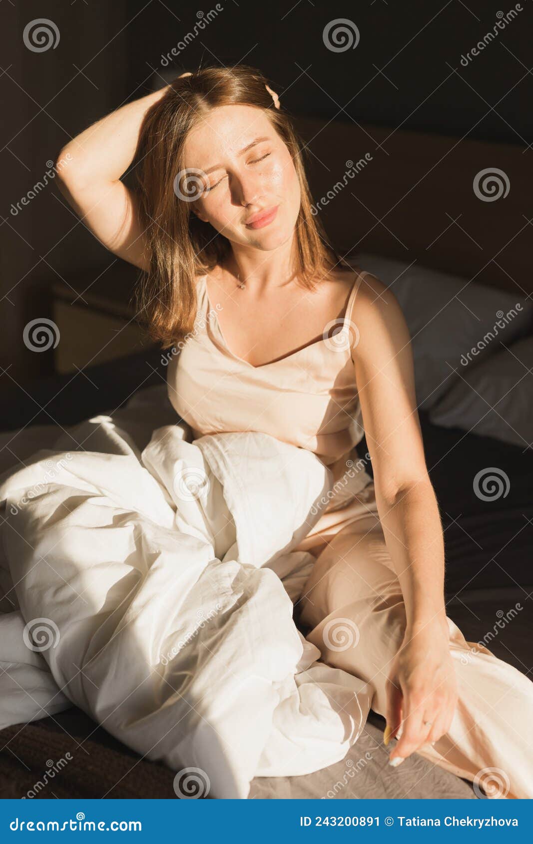 Girl Is Waking Up In Morning Stretches In Bed And Sun Shines From The