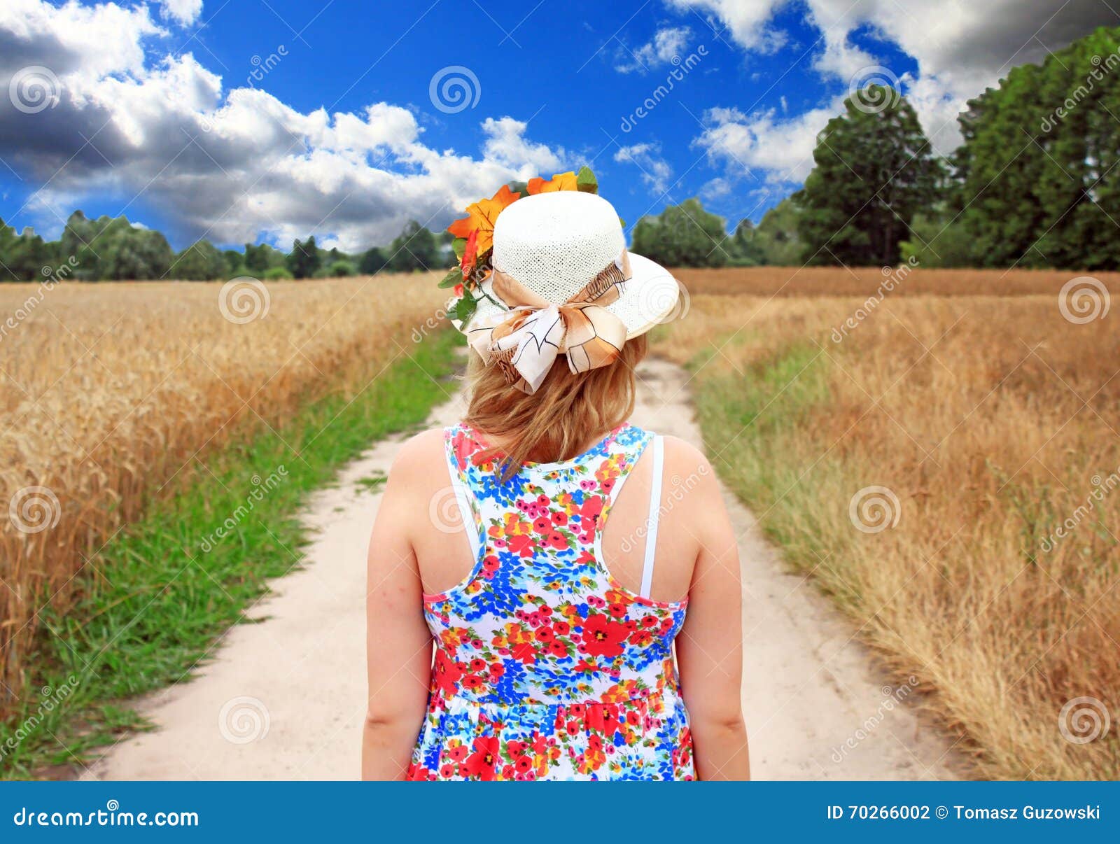 Girl Walking Along the Road in a Field Stock Photo - Image of ...