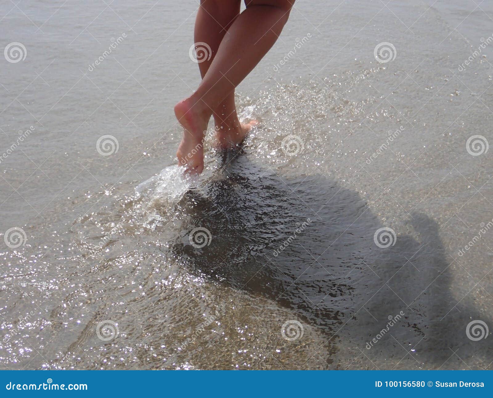 Girl Walking in the Water stock photo. Image of feet - 100156580