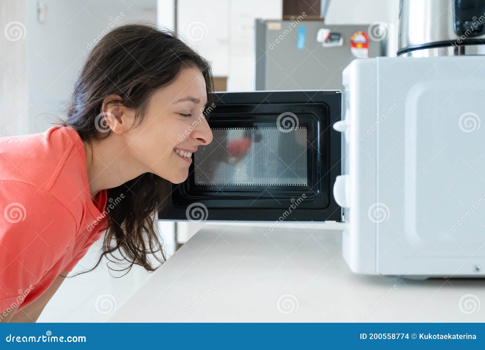 The Girl Warms Food in the Microwave. a Quick Snack Stock Photo - Image ...