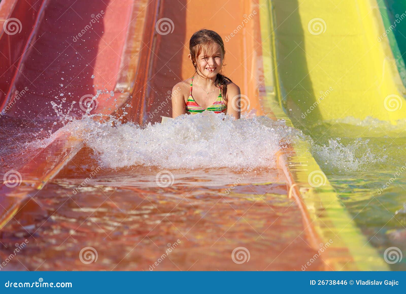 Girl on the water slide stock photo. Image of beautiful - 26738446