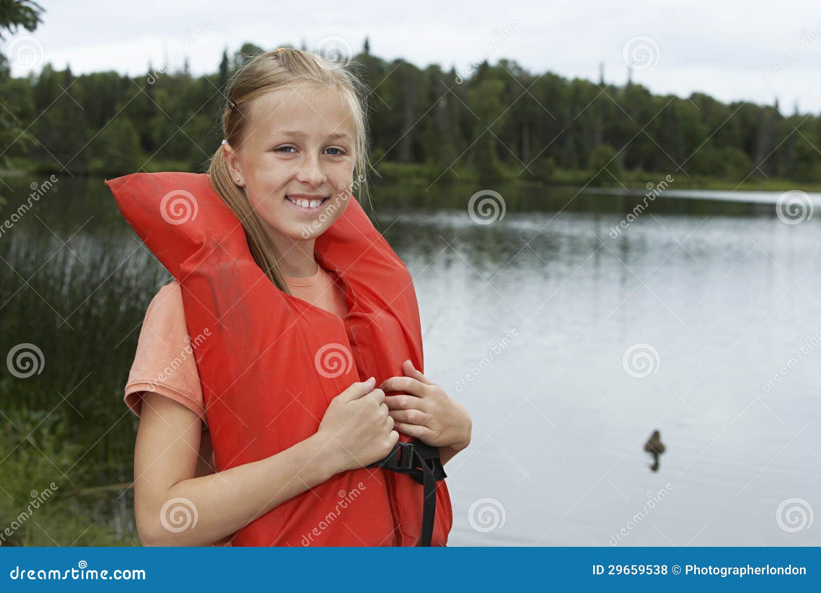 Girl Wearing Life Jacket by Lake Stock Photo - Image of lake, nature ...