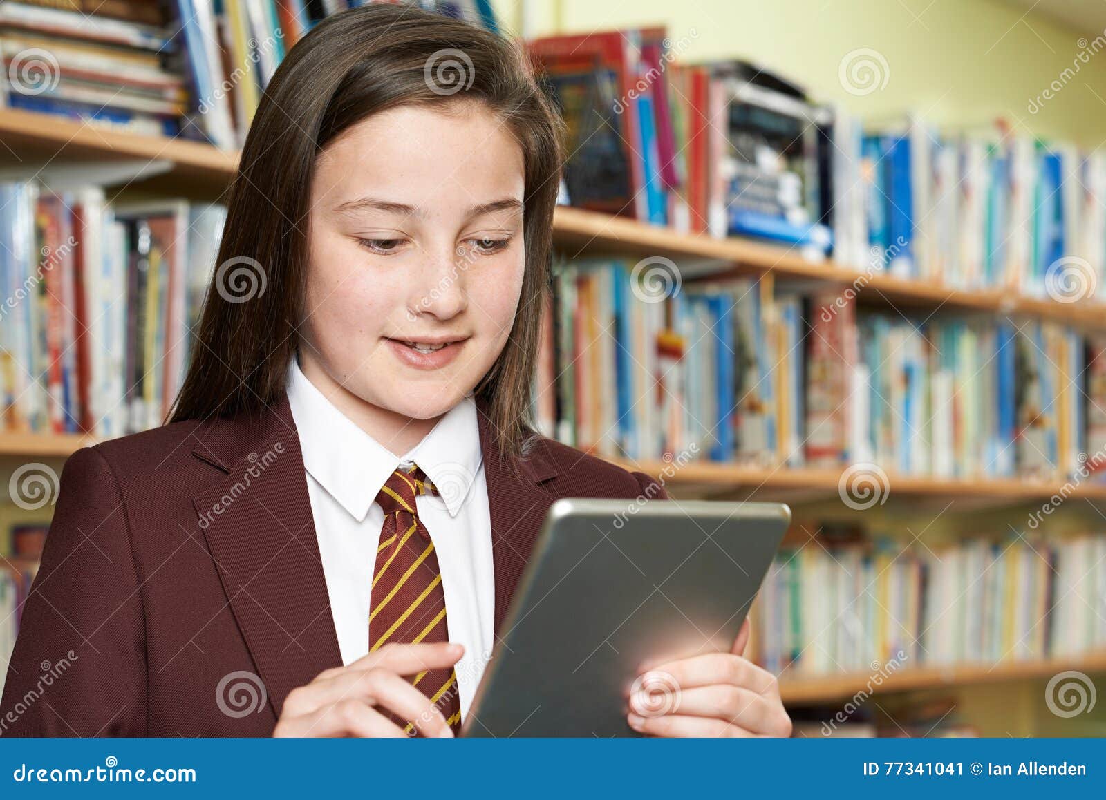 Girl Wearing School Uniform Using Digital Tablet in Library Stock Image ...