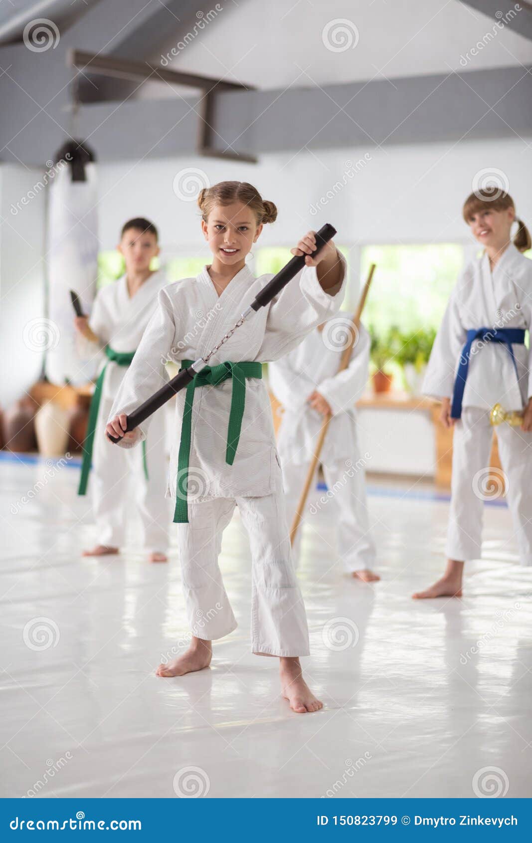 Girl in White Kimono Practicing with Nunchucks Stock Image - Image of ...