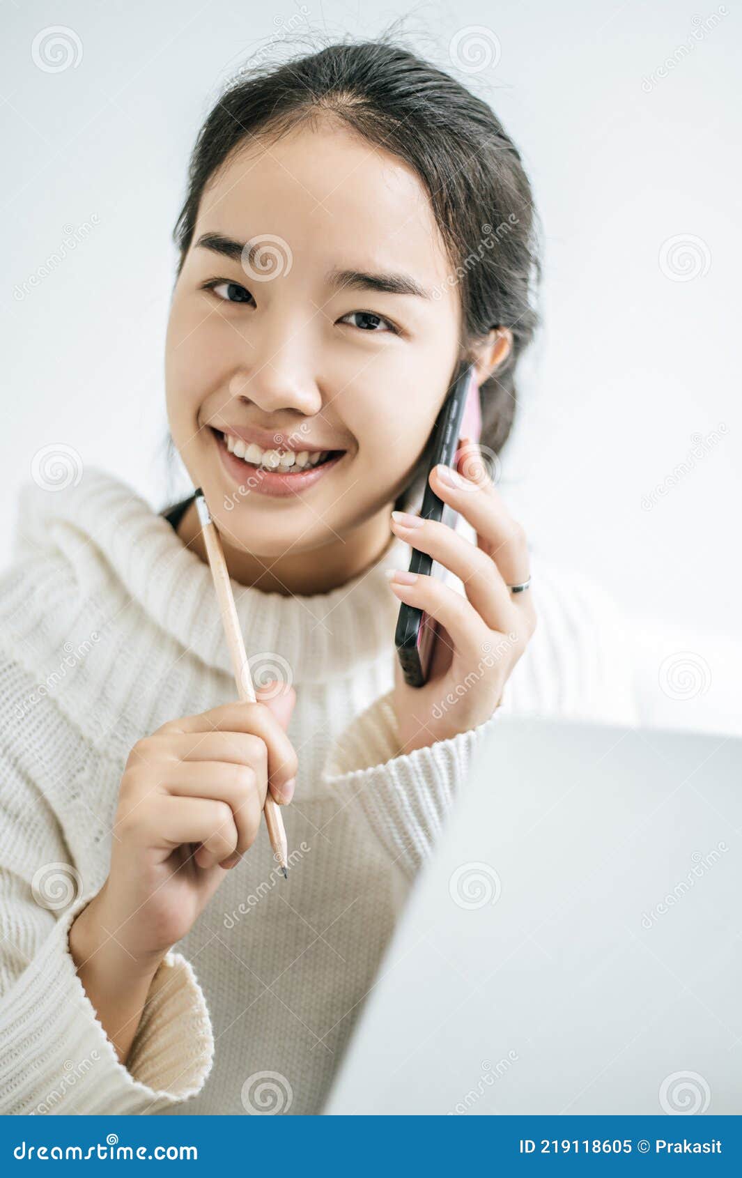 The Girl Wore A White Shirt Talking On The Phone And Happily Holding