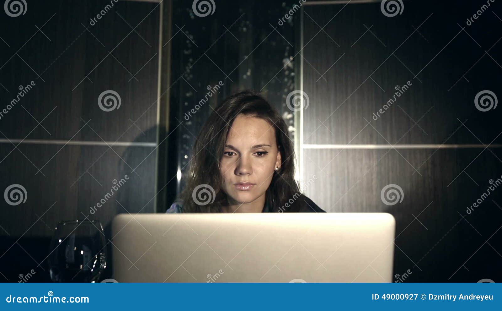 Girl Working on Computer in the Evening in the Interior with Water ...