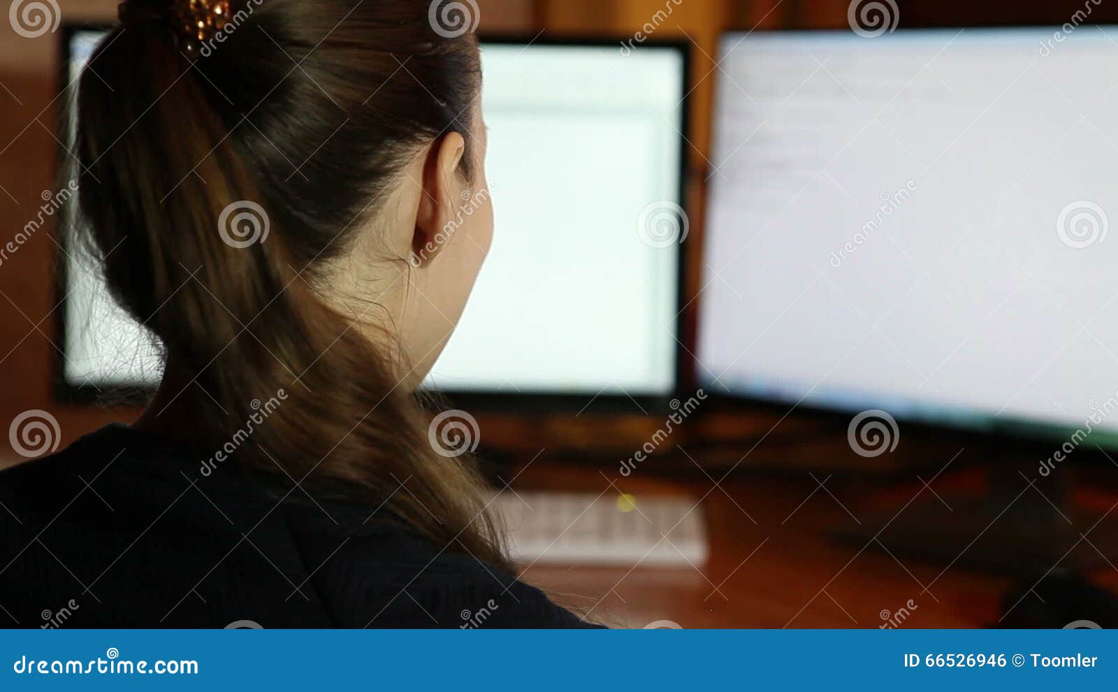 Girl Working in Front of Two Monitors, Rear View Stock Footage - Video ...