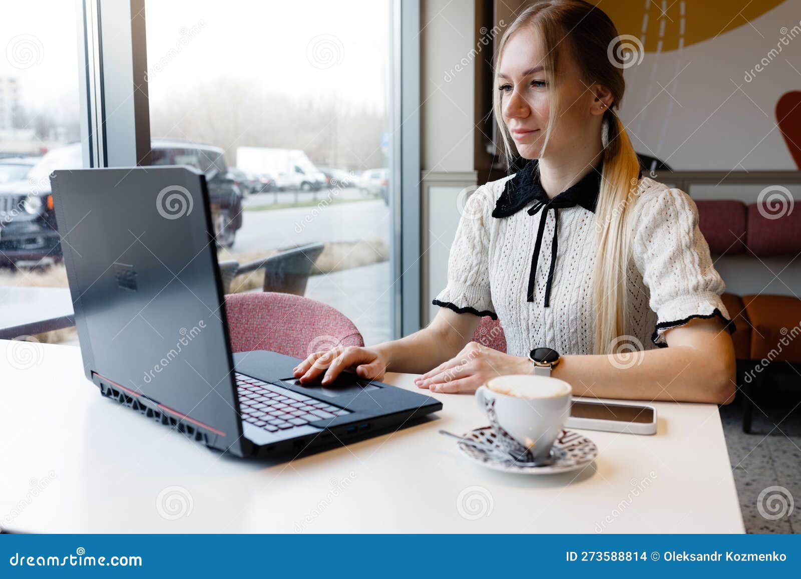 A Girl Works at a Computer in a Coffee Shop. Stock Photo - Image of ...