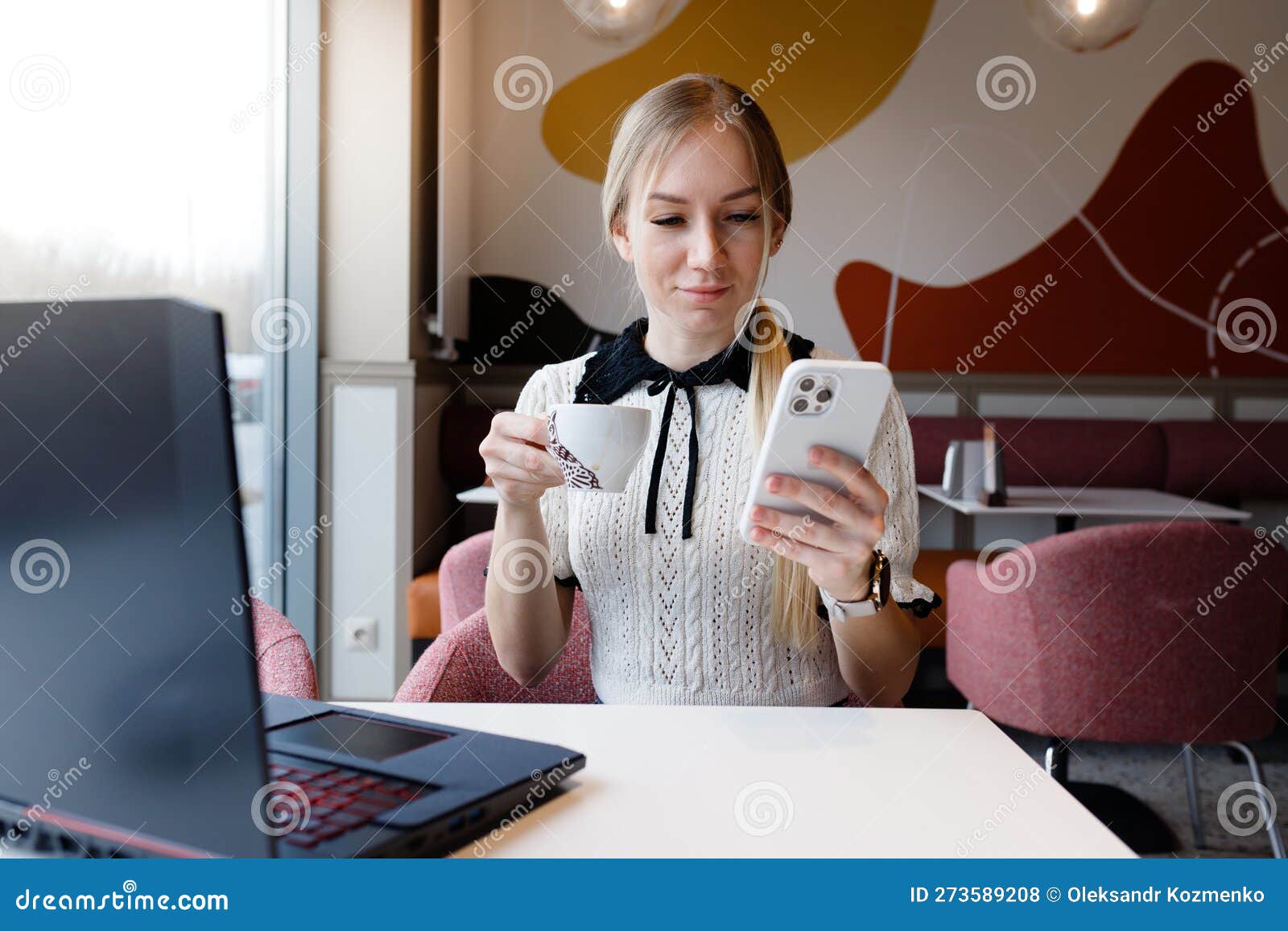 A Girl Works at a Computer in a Coffee Shop. Stock Photo - Image of ...