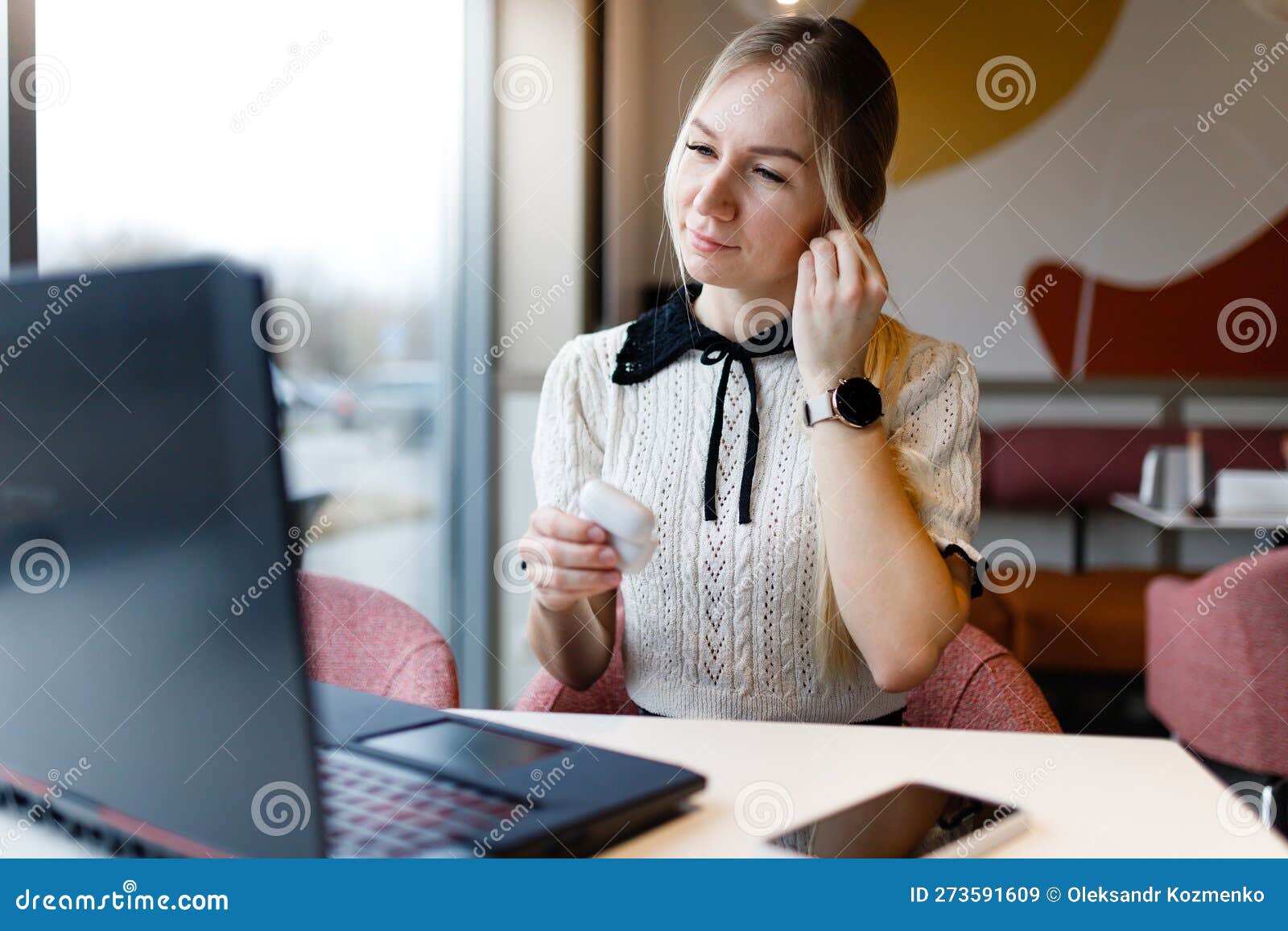 A Girl Works at a Computer in a Coffee Shop. Stock Image - Image of ...