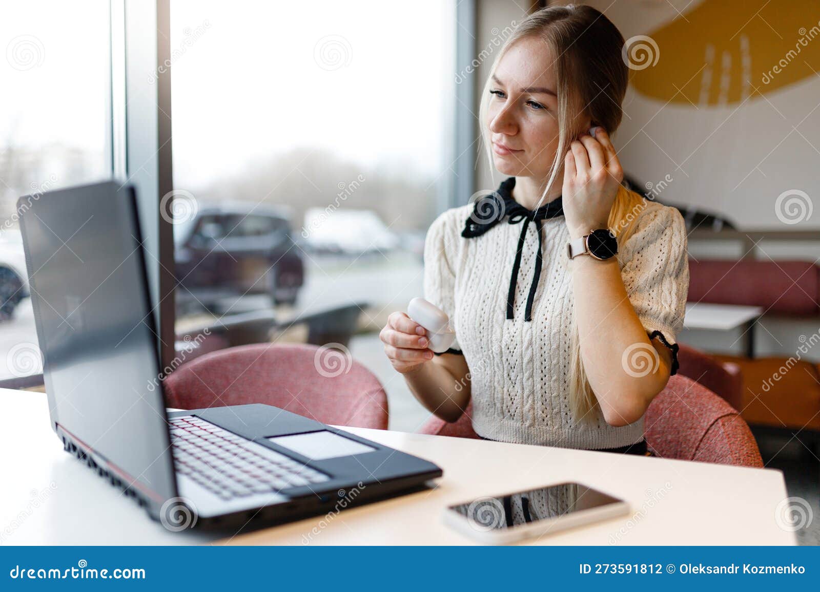 A Girl Works at a Computer in a Coffee Shop. Stock Photo - Image of ...
