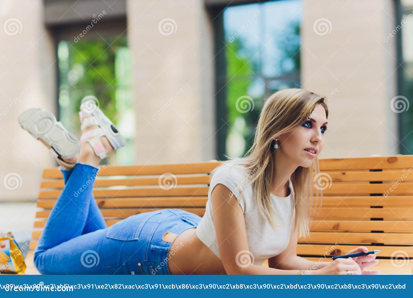 Girl Writes in a Notebook, Sitting on a Bench in the Park. Stock Photo ...