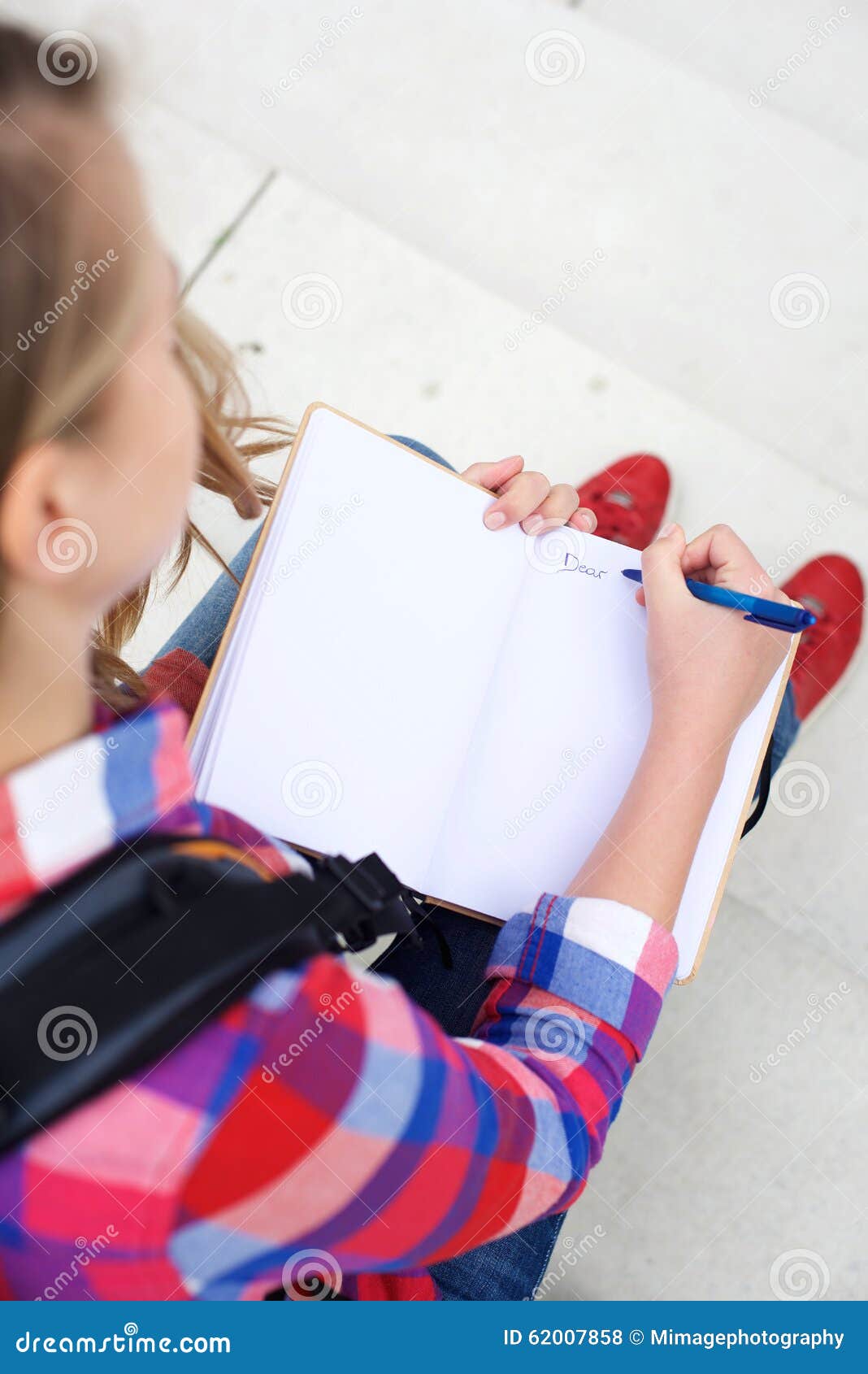 Girl writing in her diary stock photo. Image of sitting - 62007858