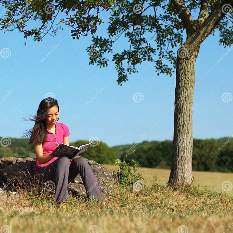 Girl Writing in Note Book stock image. Image of meadow - 6253677