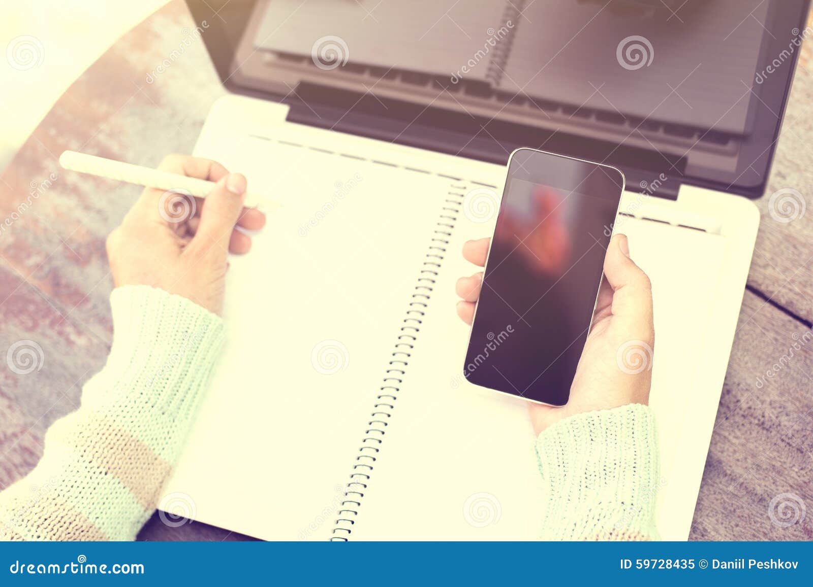 Girl Writing in a Notebook with a Cell Phone Stock Image - Image of ...