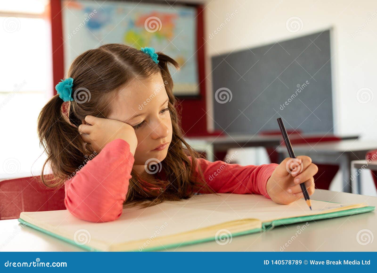 Girl Writing on Notebook in a Classroom Stock Image - Image of ...