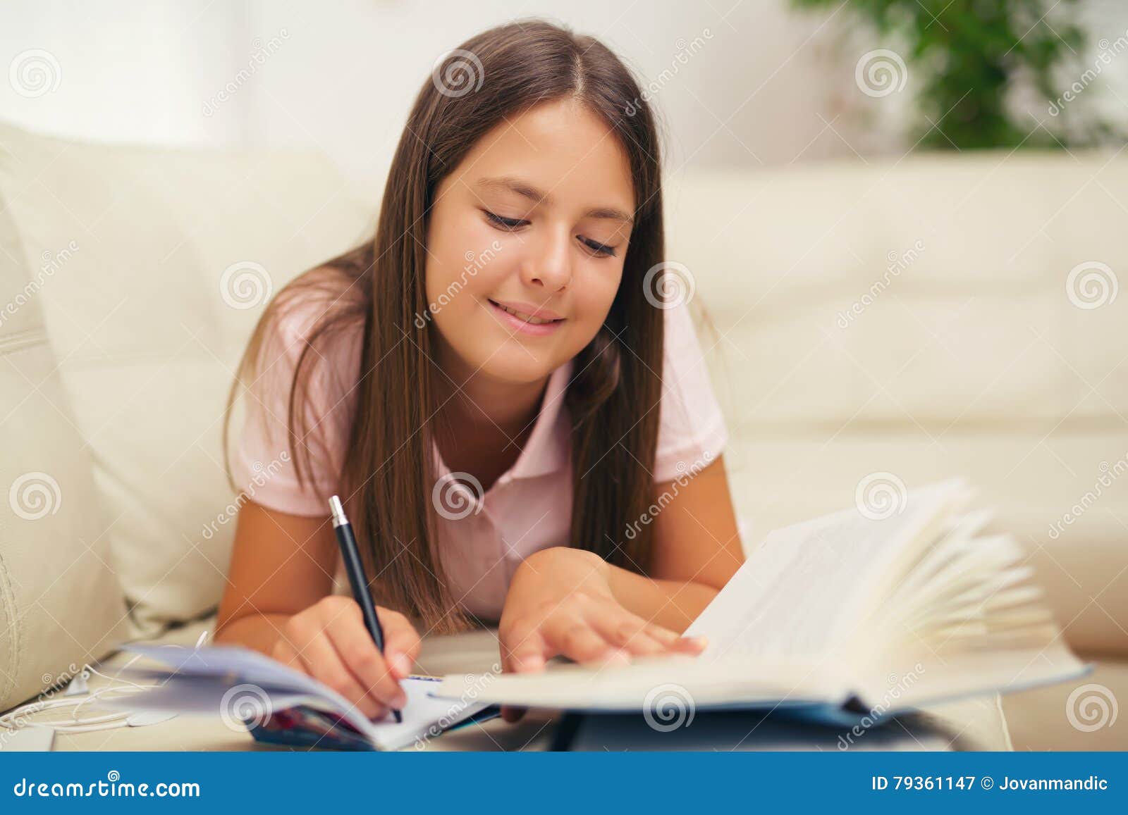Girl writing in a notebook stock image. Image of girl - 79361147