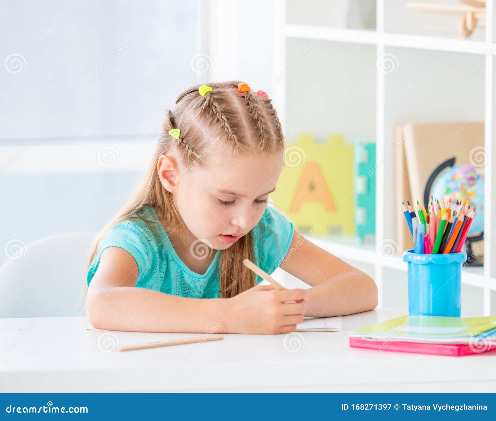 Girl writing with pencil stock image. Image of desk - 168271397