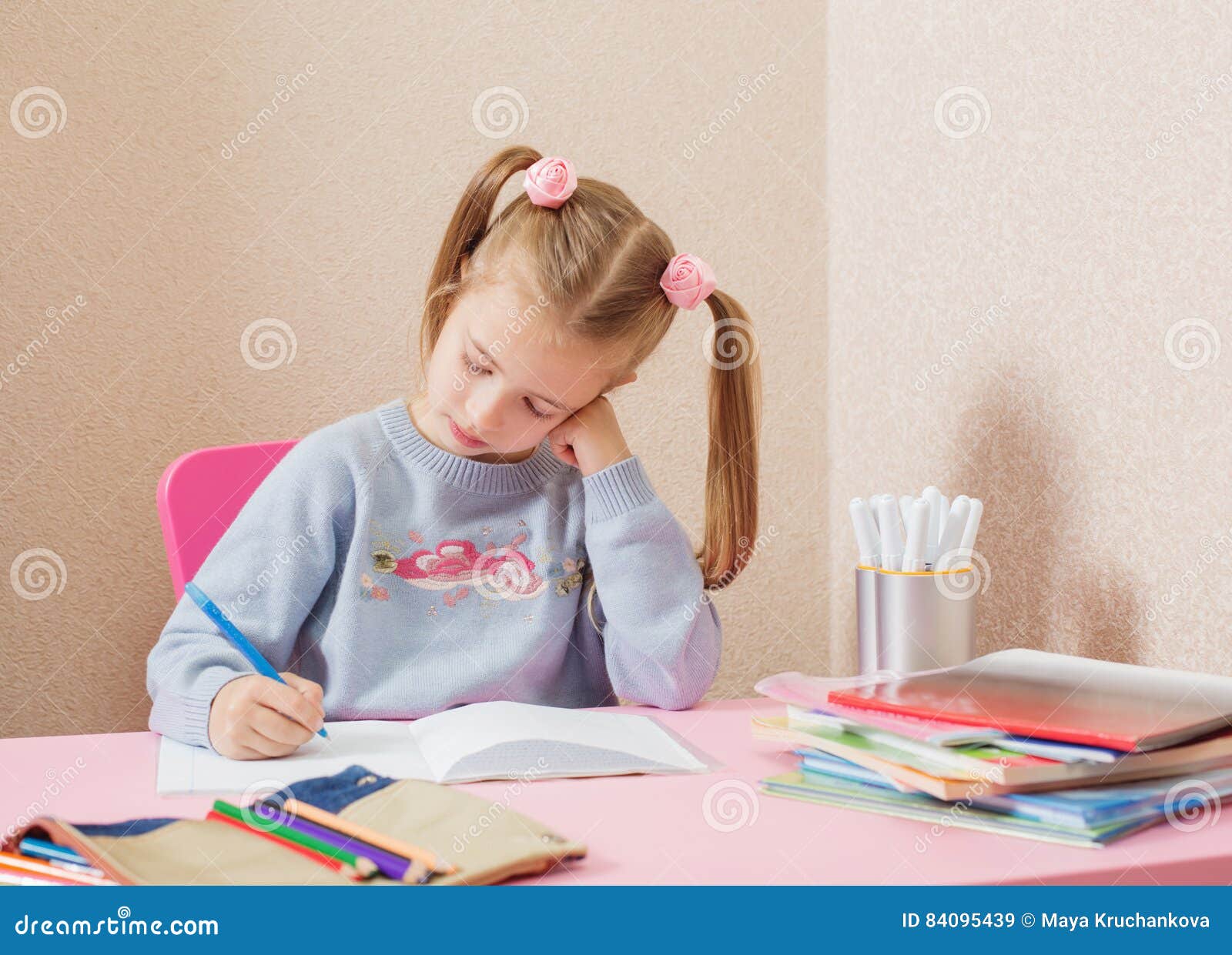 Girl writing at the table stock image. Image of pupil - 84095439