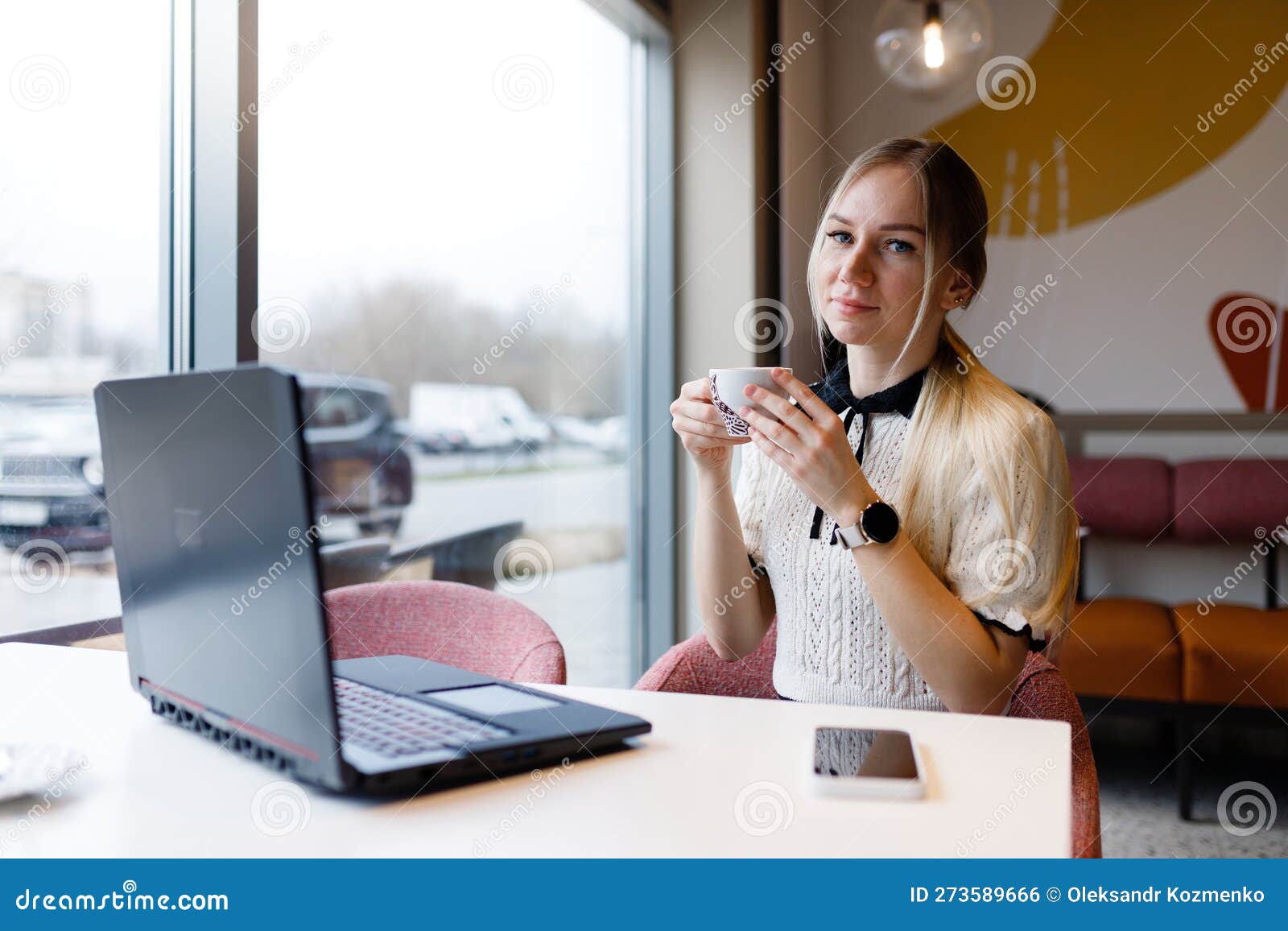 A Girl Works at a Computer in a Coffee Shop. Stock Photo - Image of ...