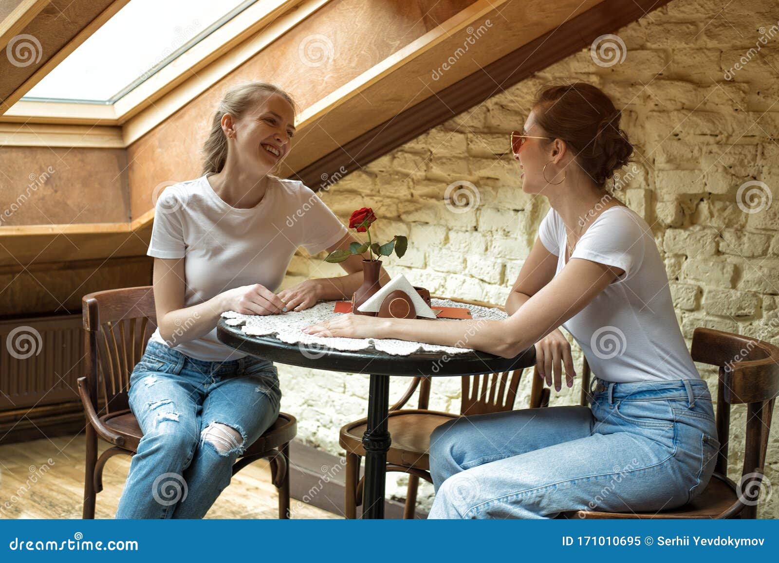Girlfriend Sitting at a Table in a Cafe, Talking and Laughing. Friendly ...