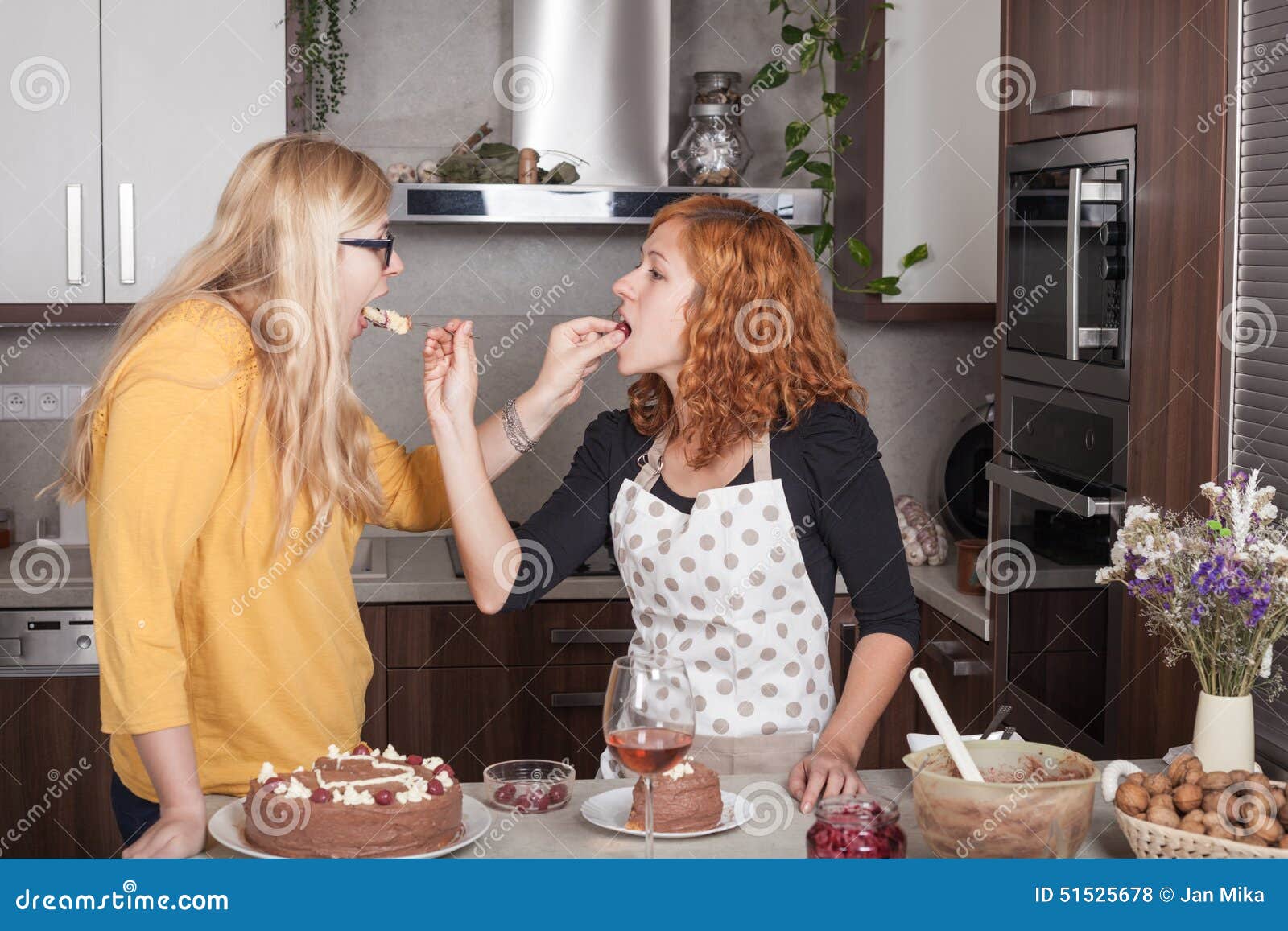 Girlfriends Feeding Each Other in the Kitchen Stock Photo - Image of ... Girlfriends Feeding Each Other in the Kitchen Stock Photo - Image of ...