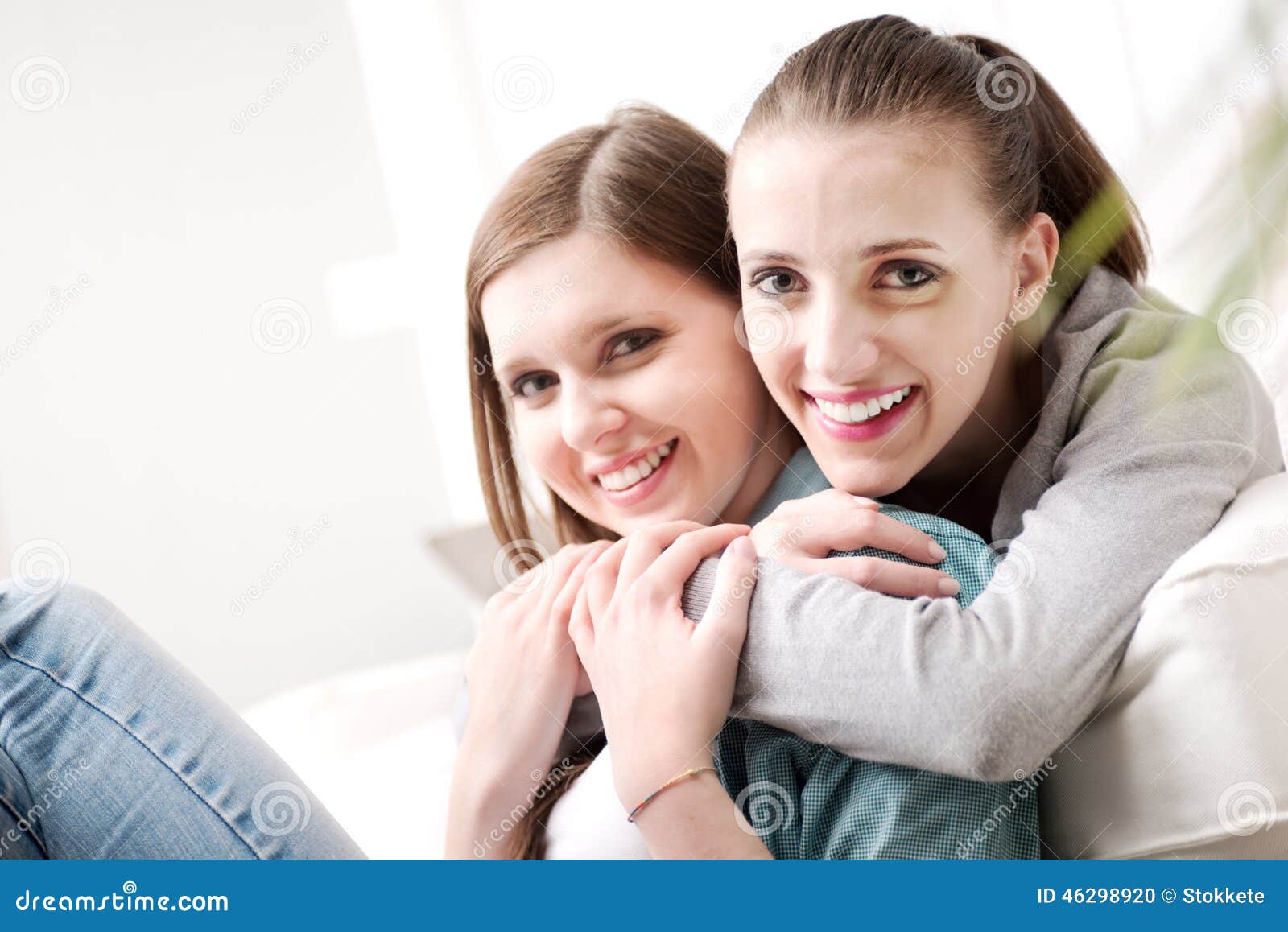 Girlfriends Hugging on Sofa Stock Photo - Image of female, comfortable ...
