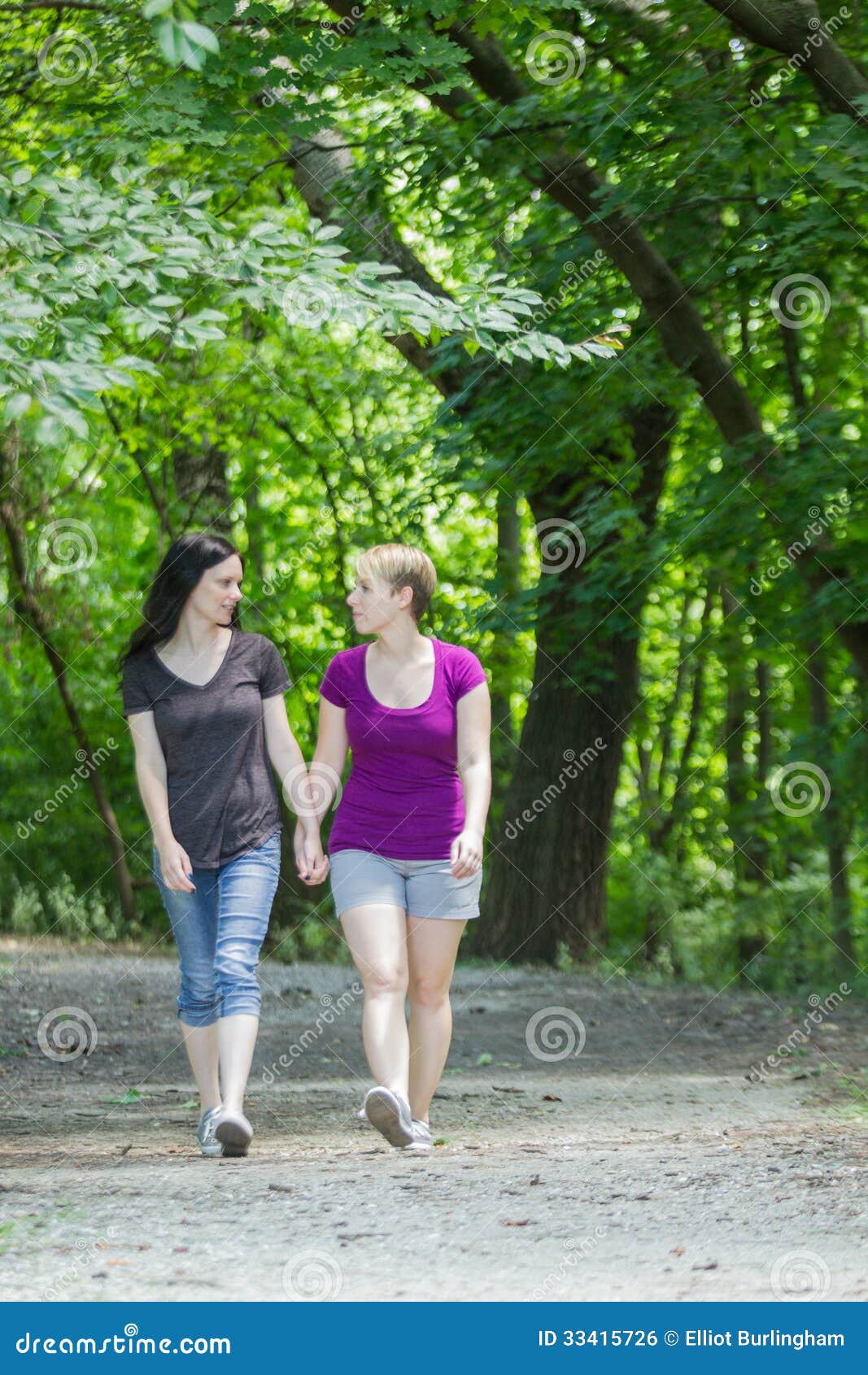 Girlfriends Taking a Walk through the Park, Vertical Stock Photo ...