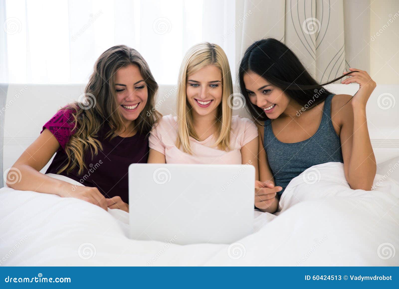 Girlfriends Using Laptop Computer in the Bed Together Stock Image ...