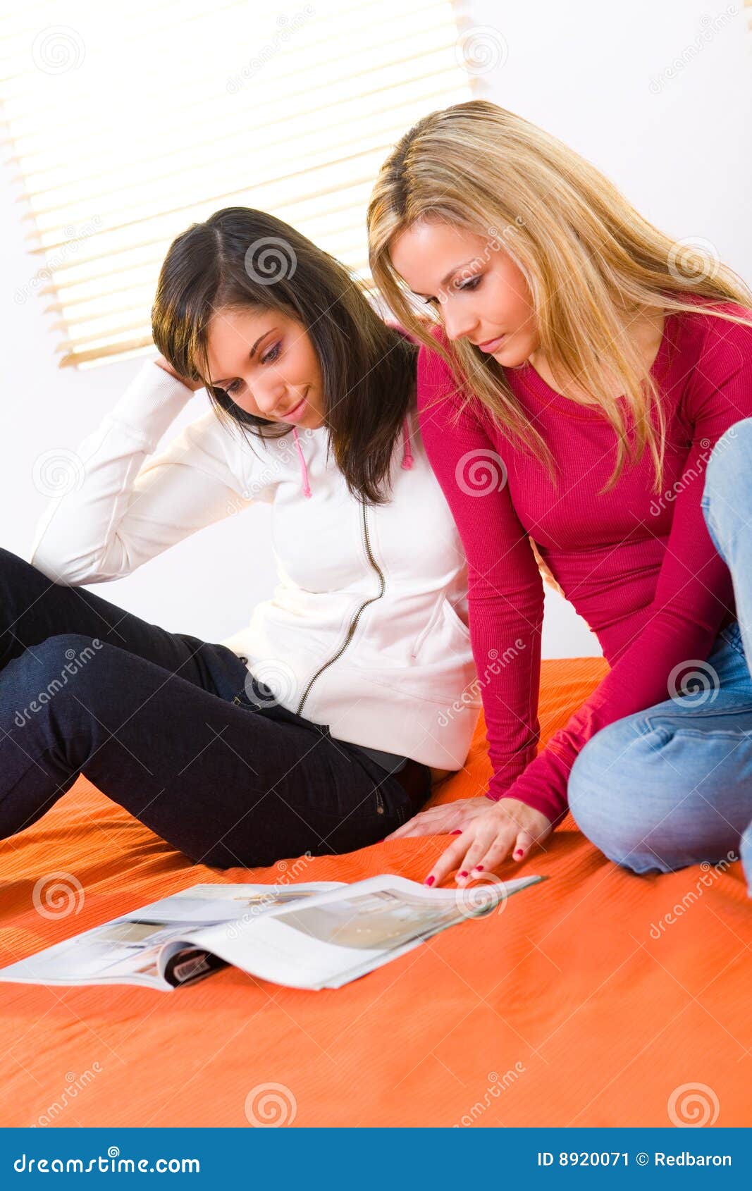 Girls browsing magazine stock image. Image of friends - 8920071