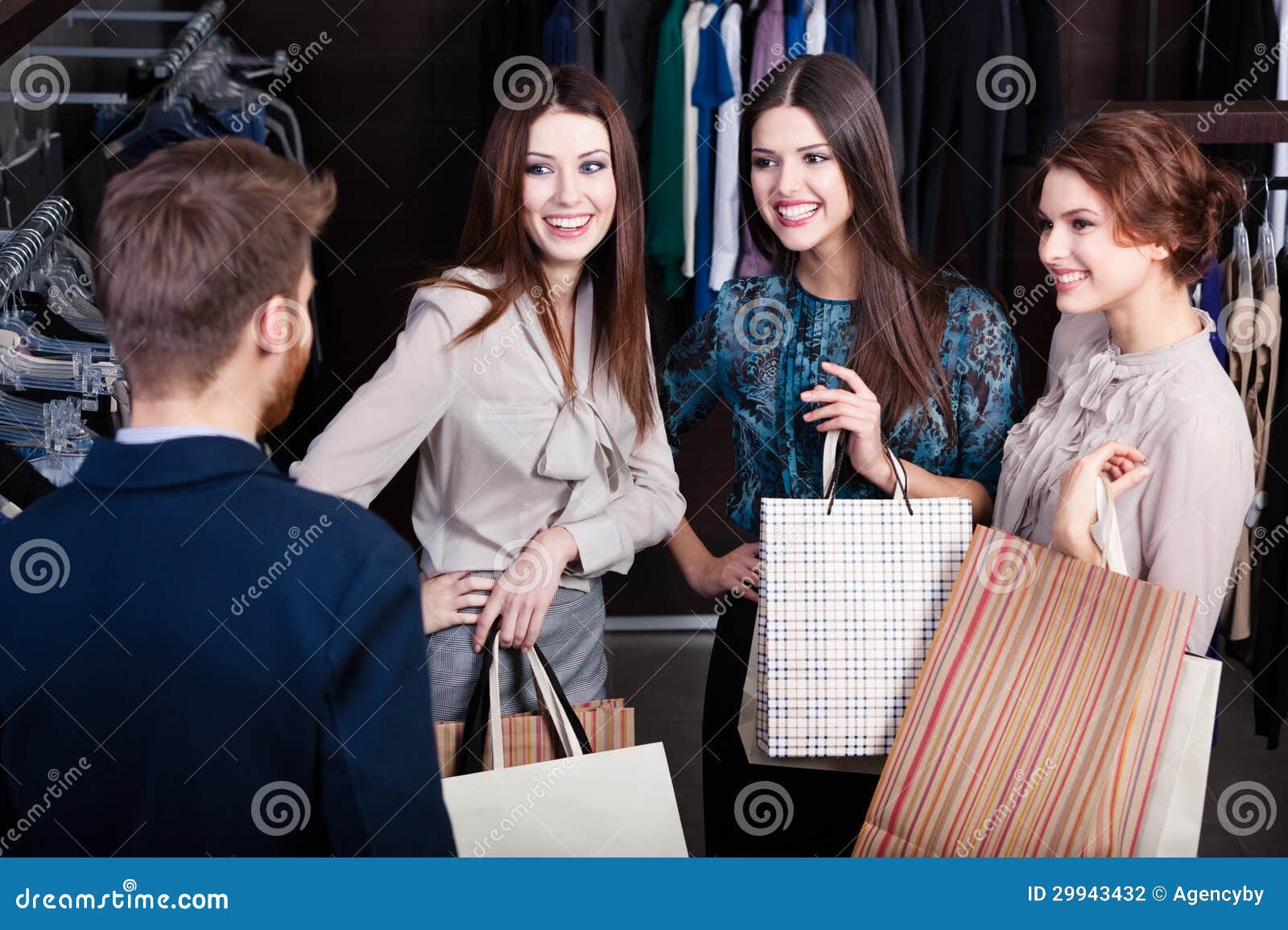 Girls Consult with Shop Assistant Stock Photo - Image of dark, friends ...