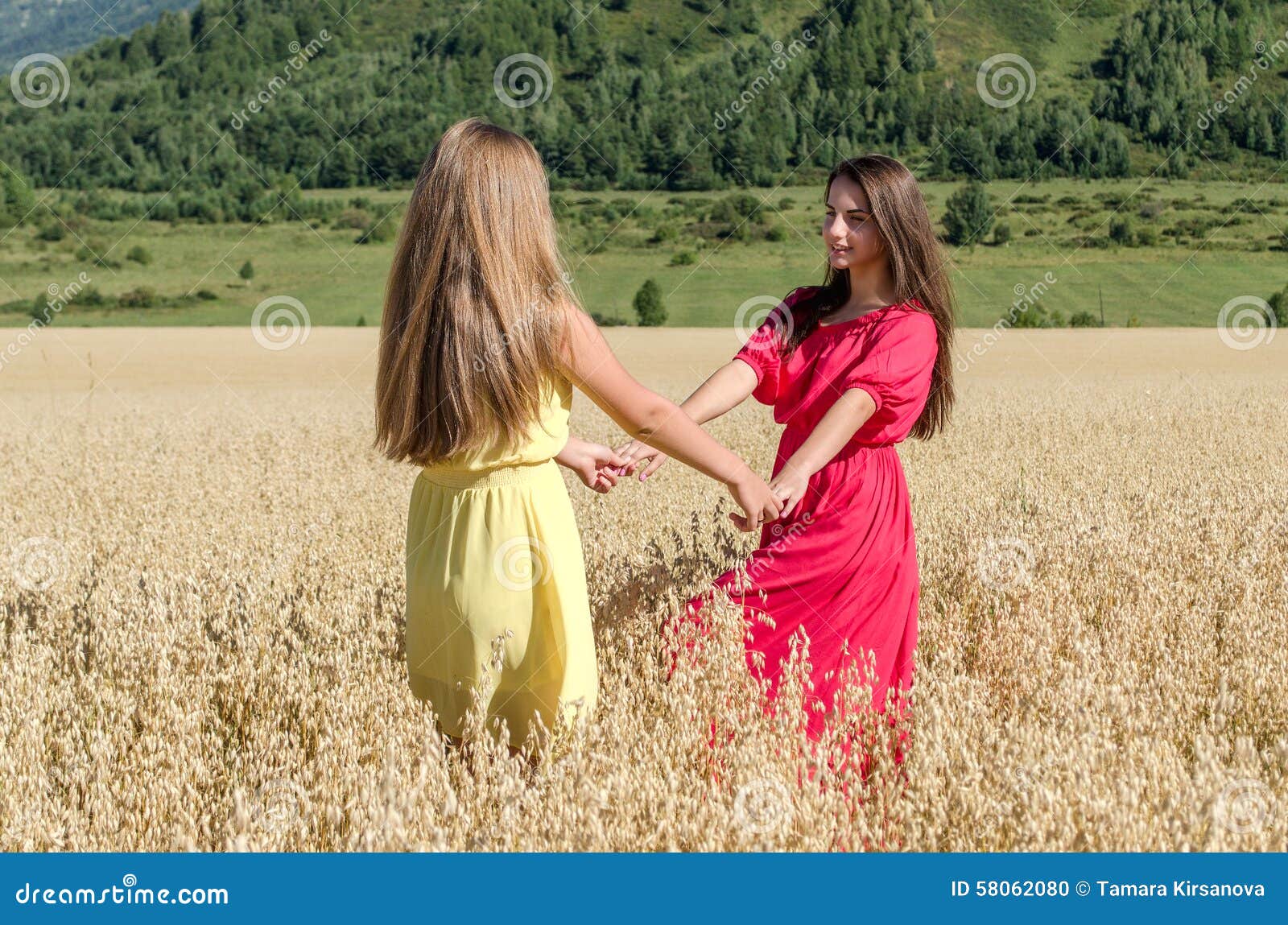 Girls dancing in a field stock photo. Image of season - 58062080