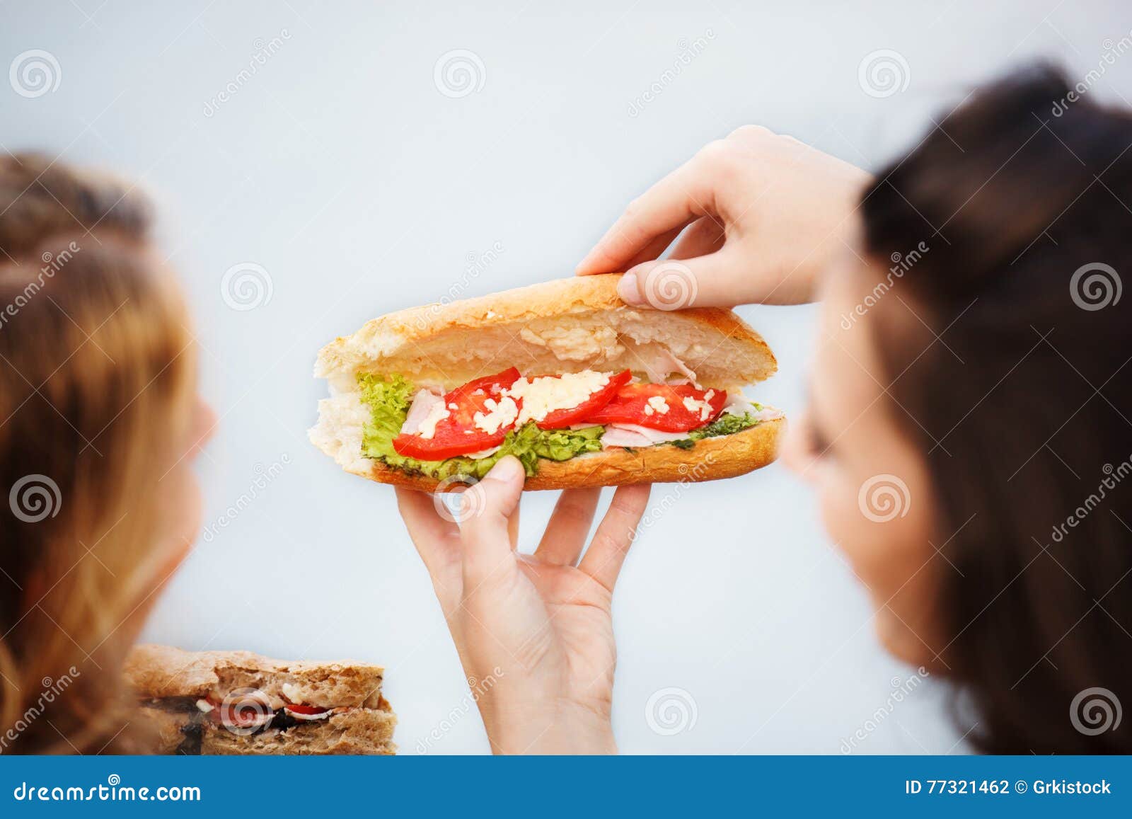 Girls Eating Sandwiches stock photo. Image of sandwiches - 77321462