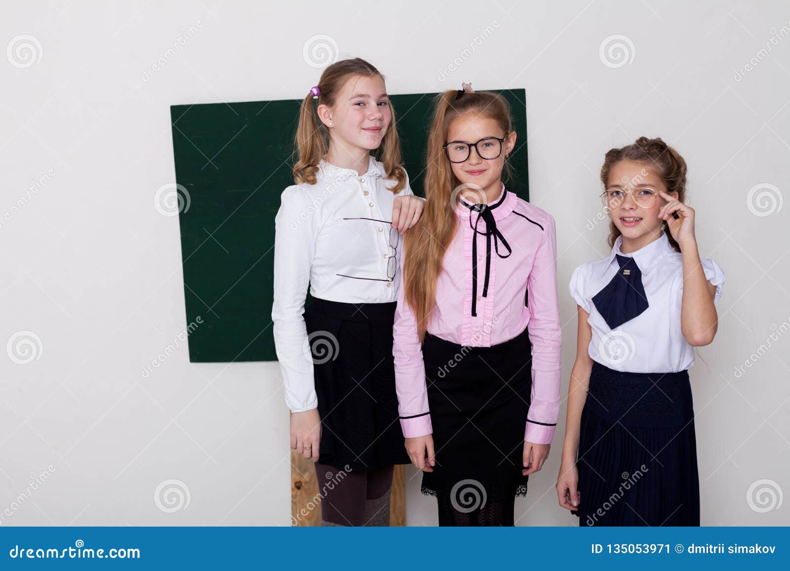 Three Girls in Glasses at the Blackboard in a Class Lesson Stock Image ...