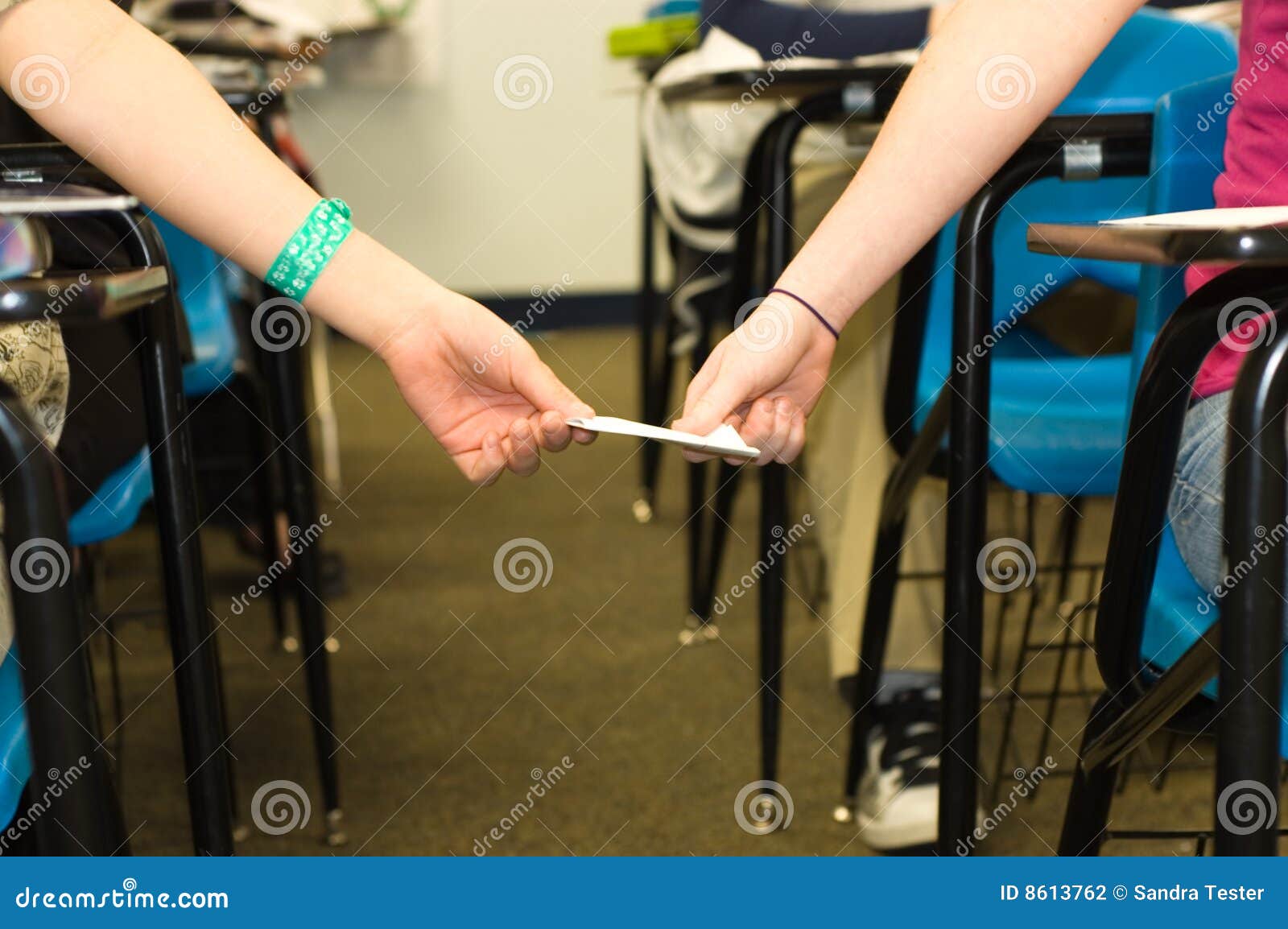 Girls hands passing a note stock photo. Image of paper - 8613762