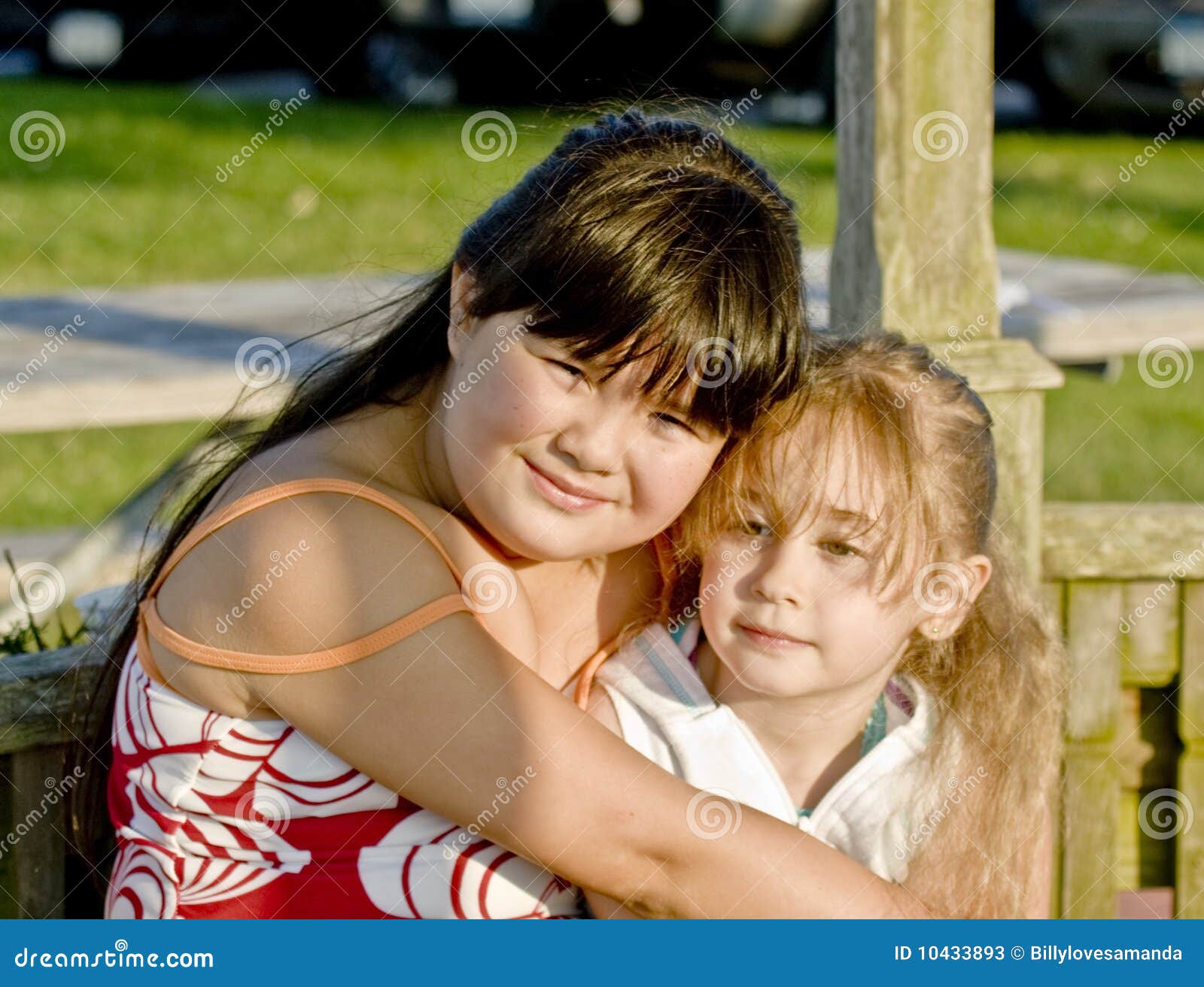 Girls hugging outdoors stock image. Image of companionship - 10433893