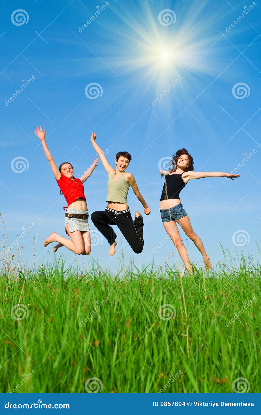 Girls jump on the meadow stock photo. Image of healthy - 9857894